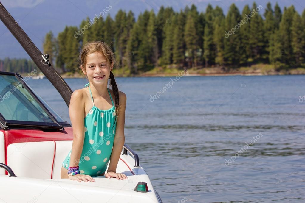 Girl riding a motorboat on a beautiful lake — Stock Photo © yobro10 ...