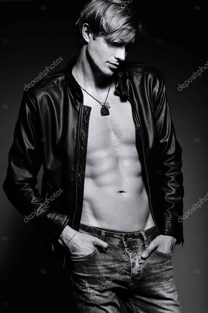 Young handsome muscled fit male model man in leather jacket posing in ...