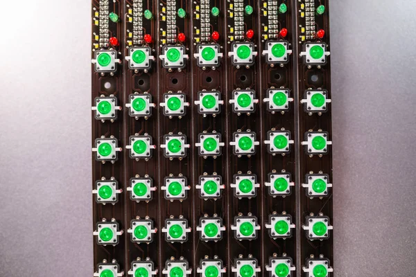 Close-up of a LED panel of green light indicators is in the production ...