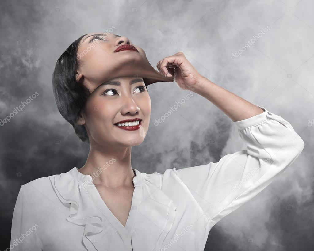 Businesswoman remove her face mask — Stock Photo © leolintang #100771372