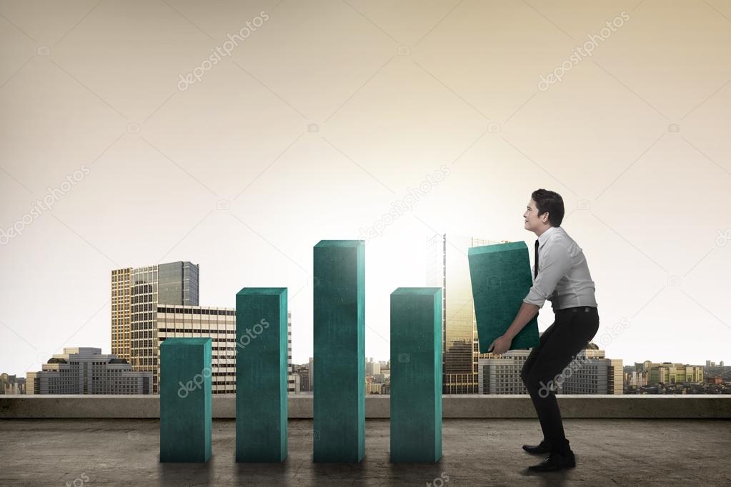 Asian businessman lifting chart block Stock Photo by ©leolintang 103418016