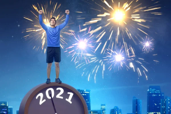 Asian runner man with a happy expression celebrating the new year with ...