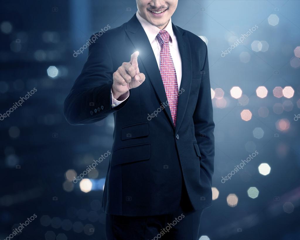 Businessman touching a touch screen Stock Photo by ©leolintang 73732101