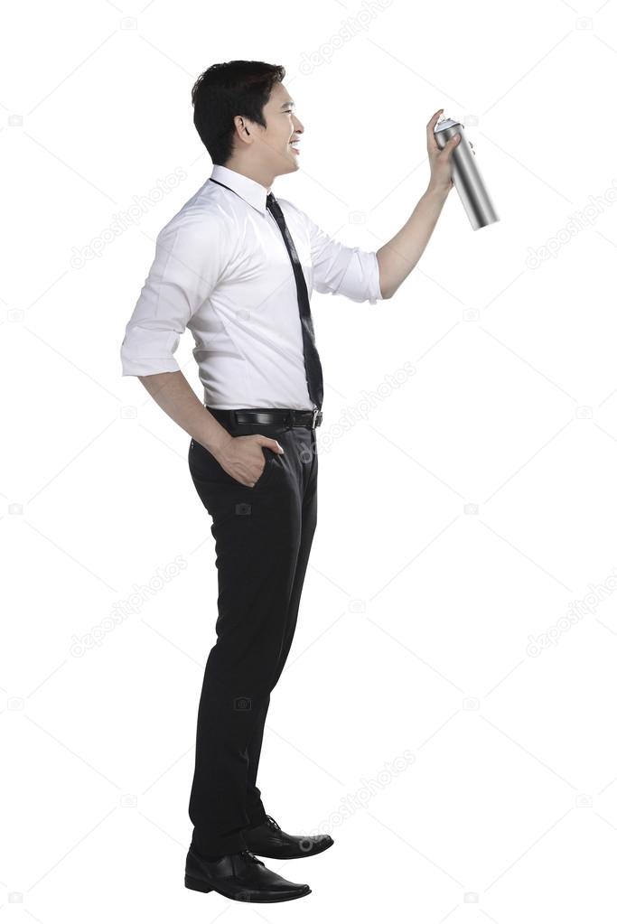Asian businessman spraying something — Stock Photo © leolintang #98543358