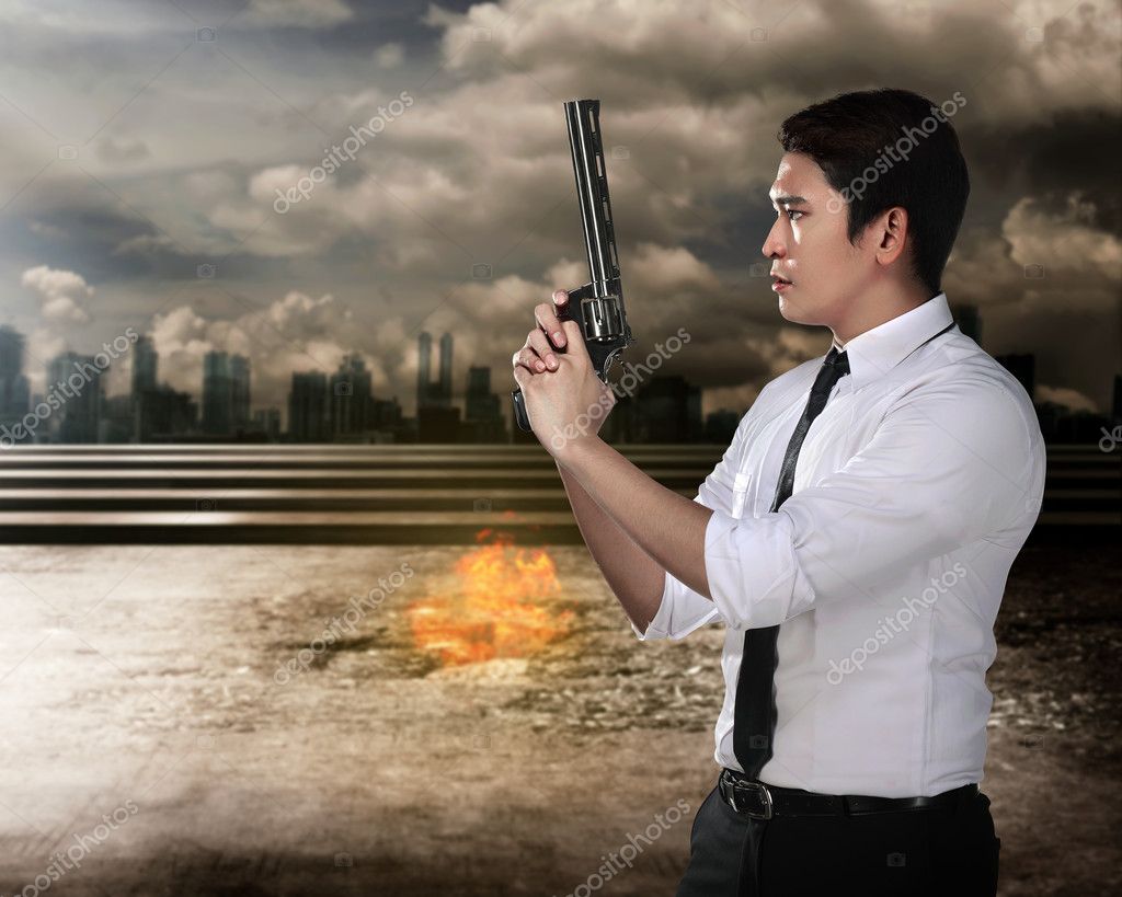 Secret Agent Holding Gun Stock Photo by ©leolintang 98543438