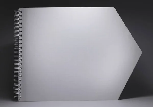 Arrow-shaped spiral notebook. Go ahead, go on, move forward concept ...