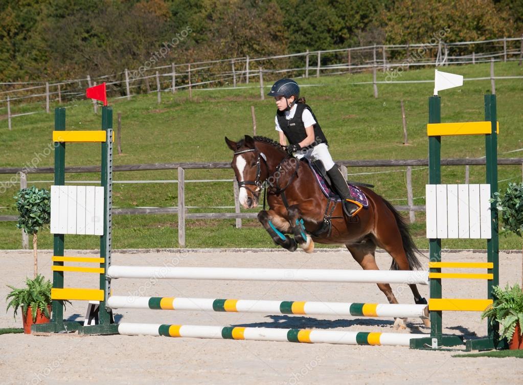 Girl on showjumping competition — Stock Photo © scigelova #79748058