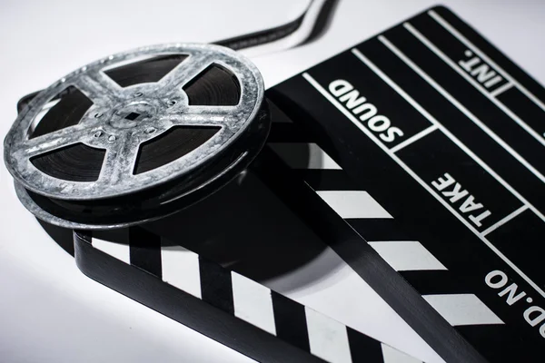 Old rusty roll of film and cinema clap Stock Photo by ©kanzefar 103771412