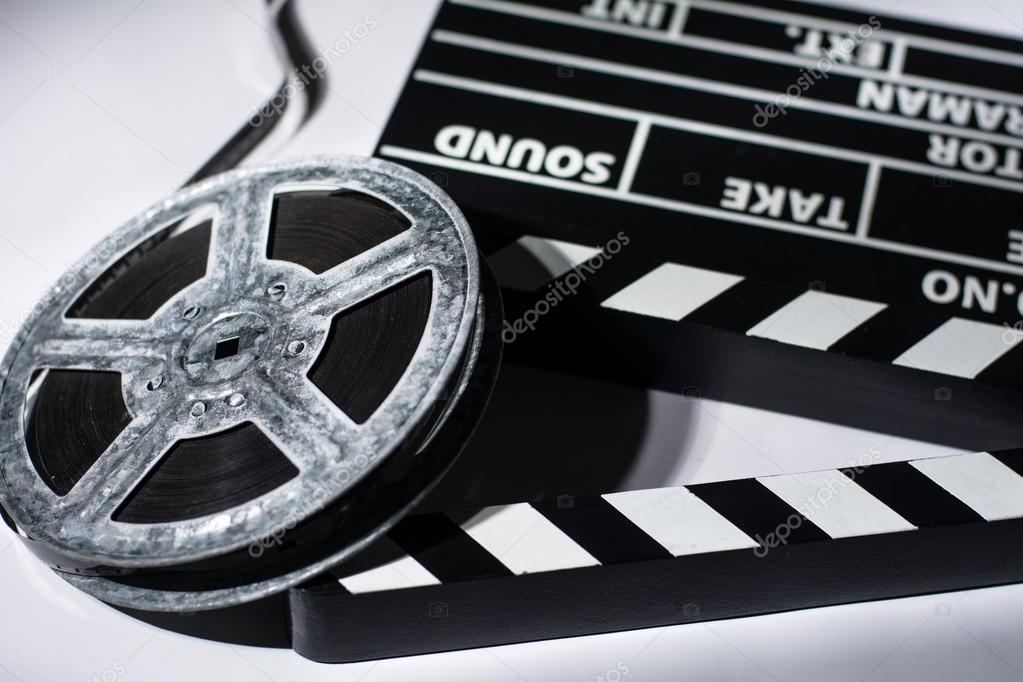 Old rusty roll of film and cinema clap Stock Photo by ©kanzefar 103771412