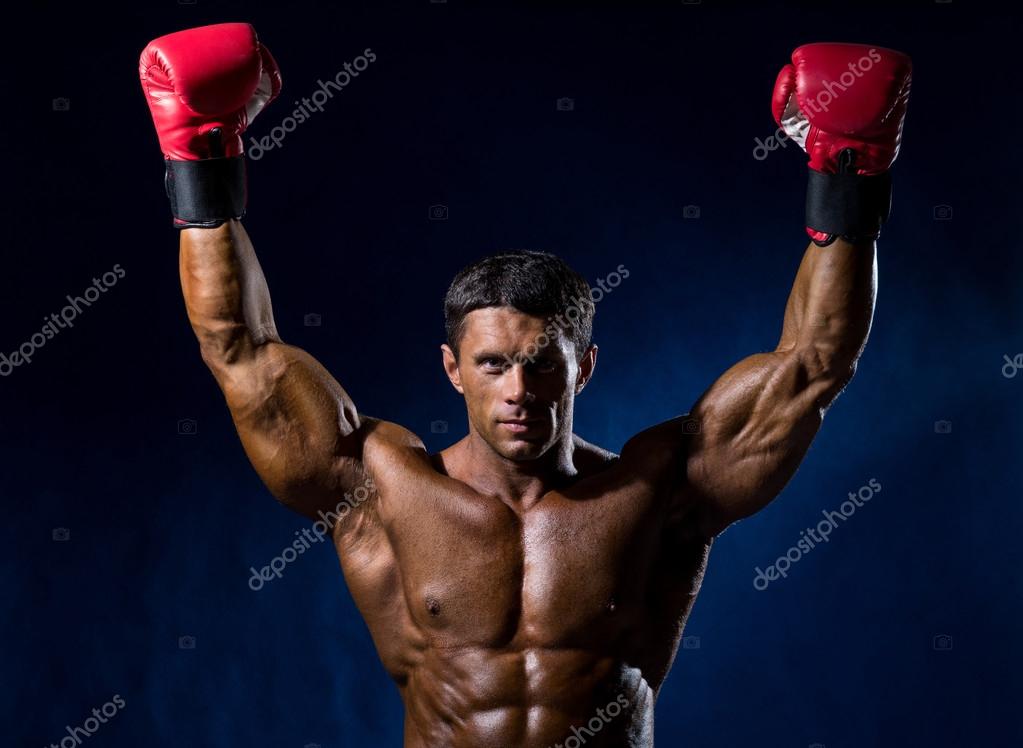 Strong muscular boxer in red boxing gloves raised his hands abov Stock ...