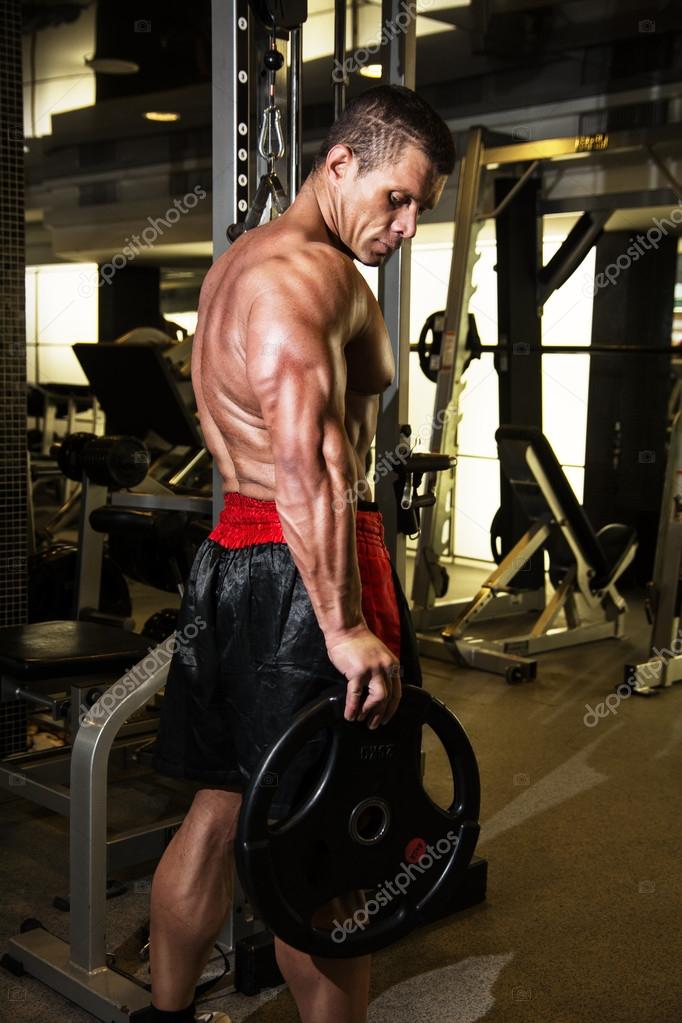 Bodybuilder in the gym. Stock Photo by ©kanzefar 83708262