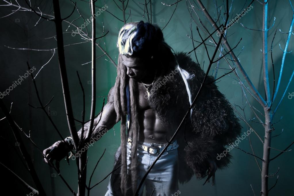 Muscular werewolf among the branches of the tree — Stock Photo ...
