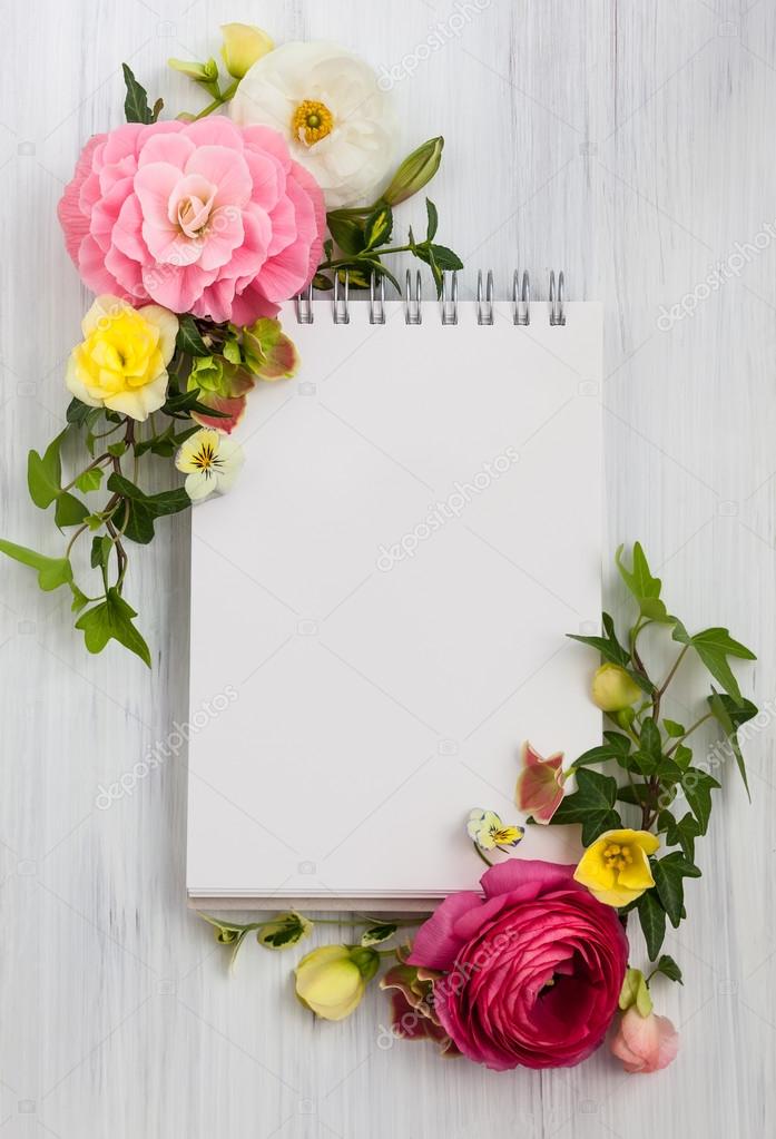 Flowers and notepad with copy space Stock Photo by ©sarsmis 71410203