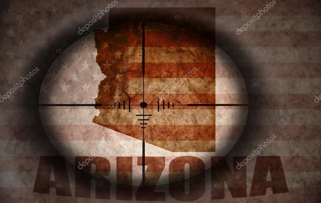Sniper scope aimed at the vintage american flag and arizona state map ...