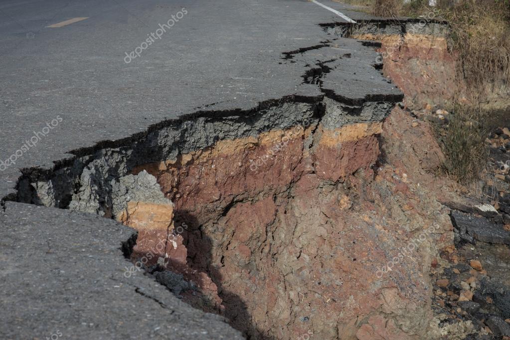 Side of the broken asphalt road collapsed and fallen — Stock Photo ...