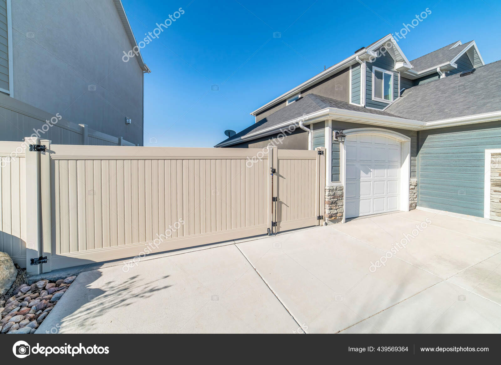 Wide gate that leads to the yard beside the detached two car garage of ...