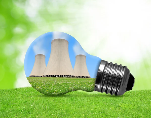 Hand holding bulb with nuclear power plant — Stock Photo © vencav #58872381
