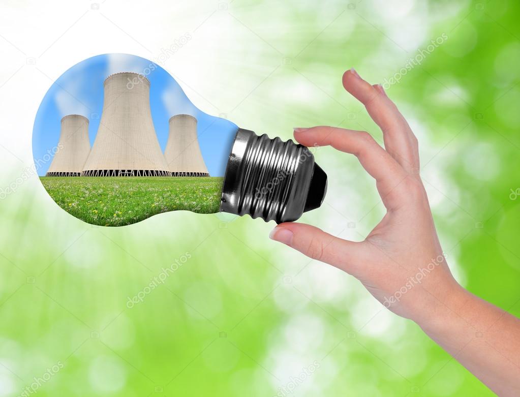 Hand holding bulb with nuclear power plant — Stock Photo © vencav #58872381
