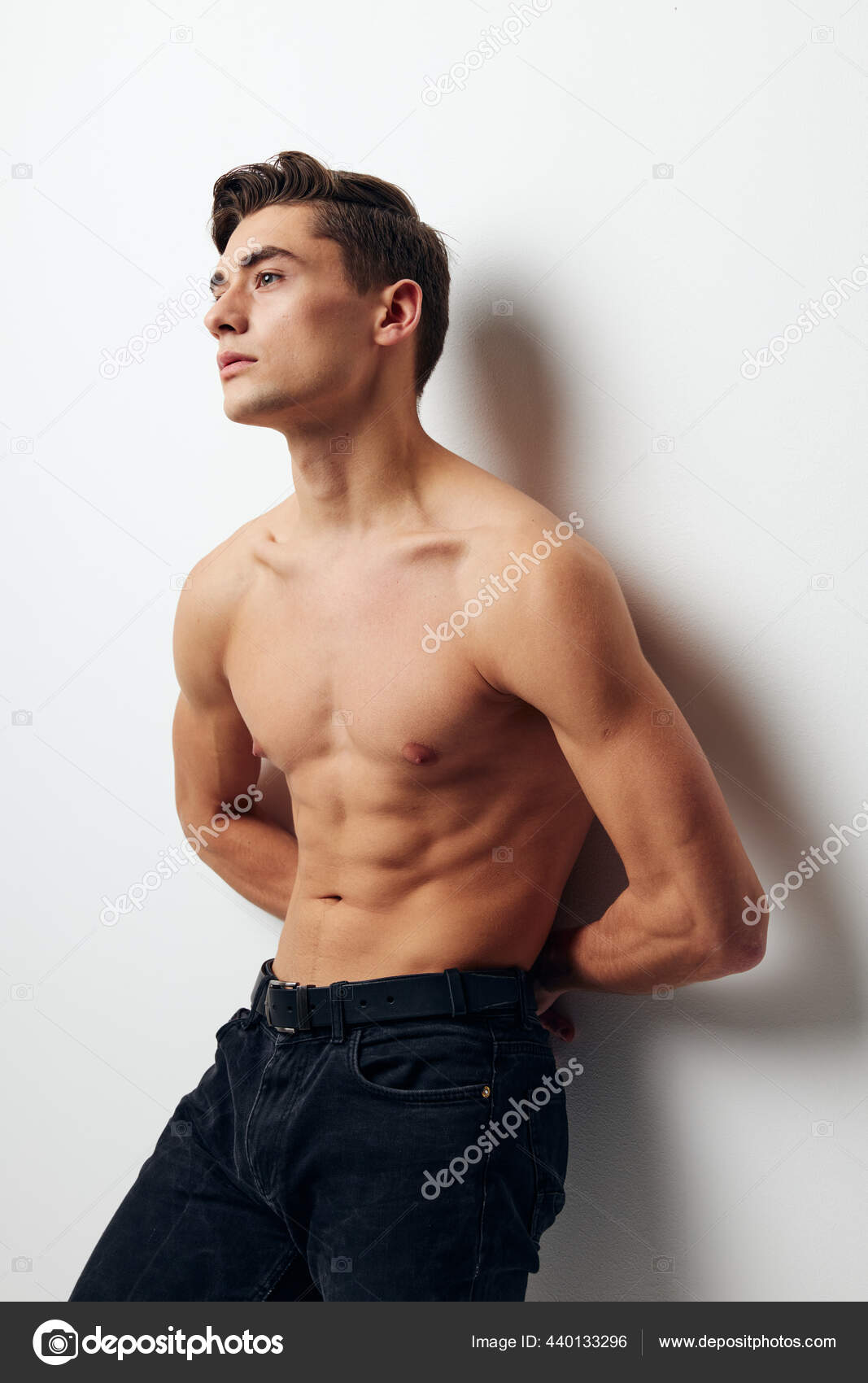 The guy has a low tone near a white wall in the room Stock Photo by ...
