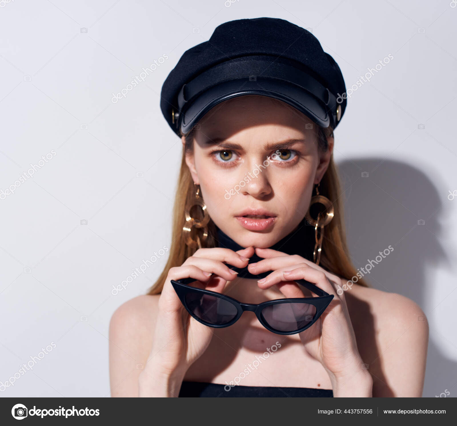 Pretty woman leather black cap on her head cosmetics glamor close-up ...