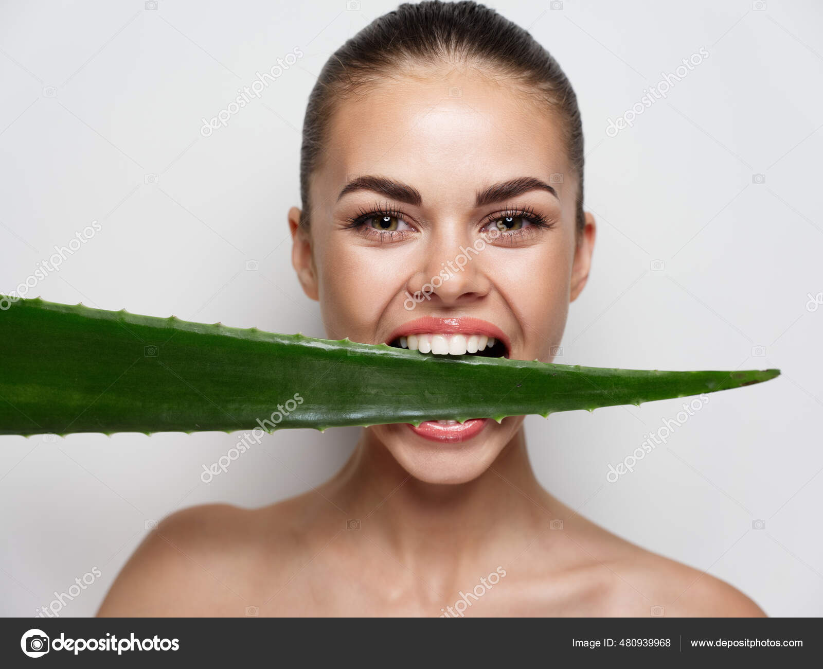 Woman biting an aloe leaf on a light background vitamins — Stock Photo ...