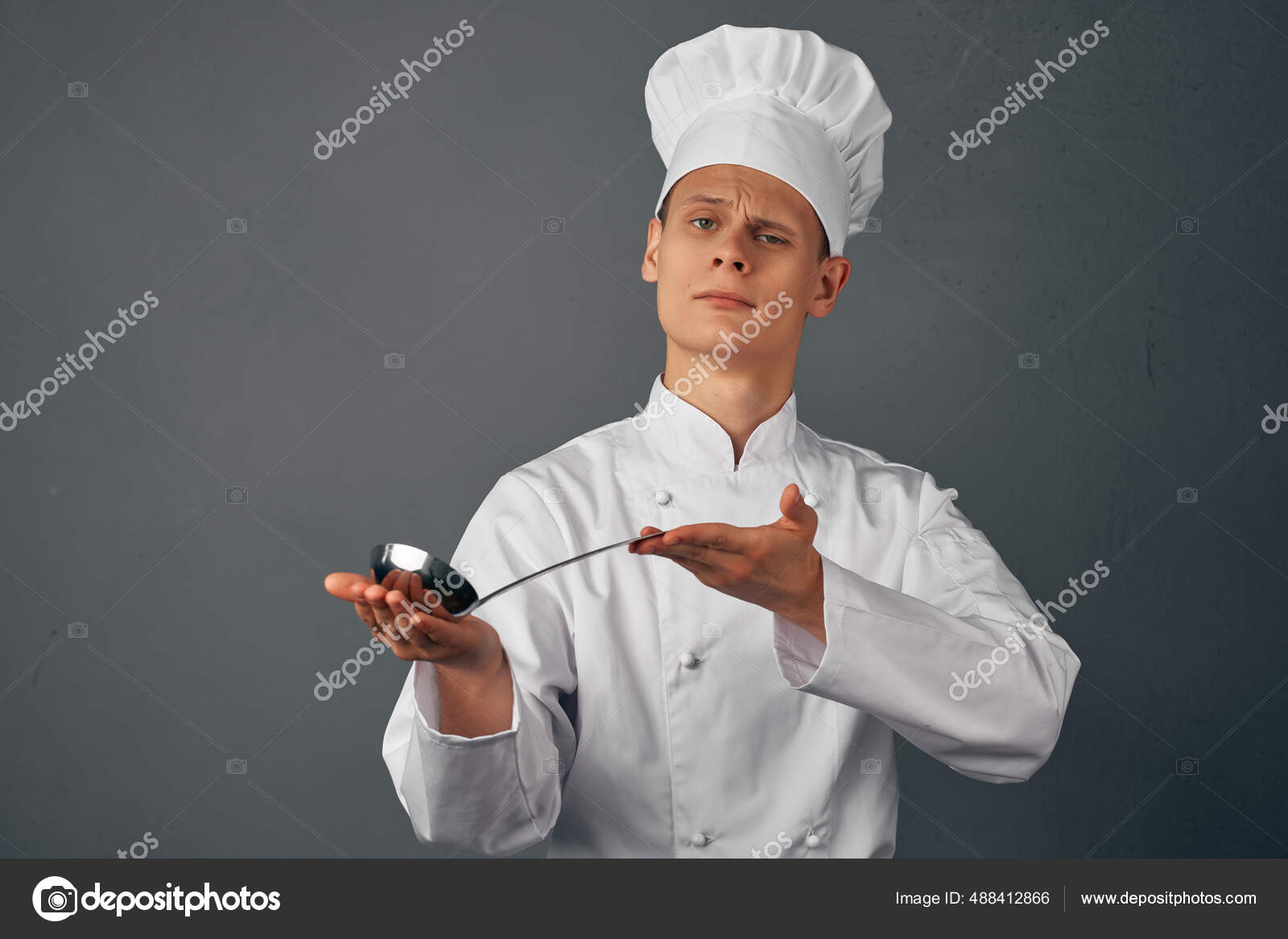 Chef with a ladle in his hands is trying dishes restaurant professional ...