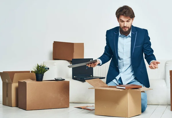 manager packs things from office new place of work - Stock Image ...
