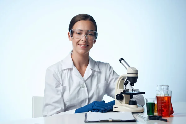 Cheerful woman laboratory assistant science microscope biotechnology ...