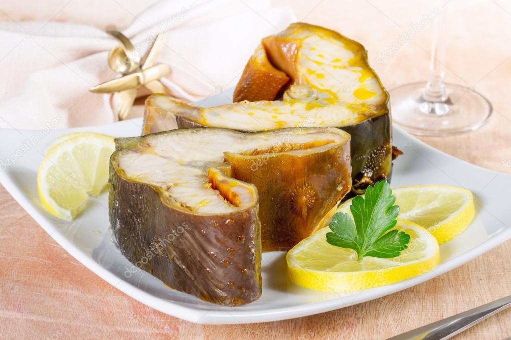 Smoked sturgeon fillet on a platter Stock Photo by ©g215 103098890