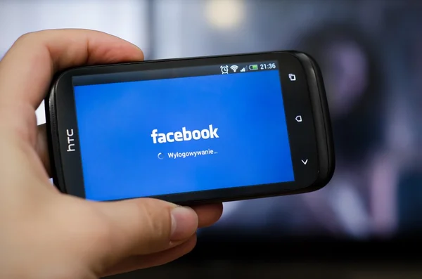 Hand holding smartphone with Facebook social network mobile app - Stock ...