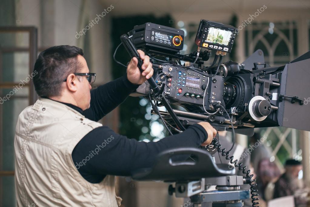 Professional camera man at work Stock Photo by ©danr13 78258470
