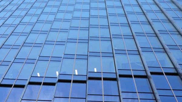 Facade texture of a glass mirrored office building. A beautiful ...