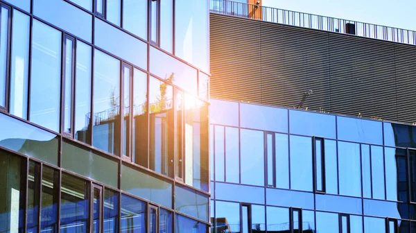 Reflection of modern commercial building on glass with sunlight. Geometric structure glass ...