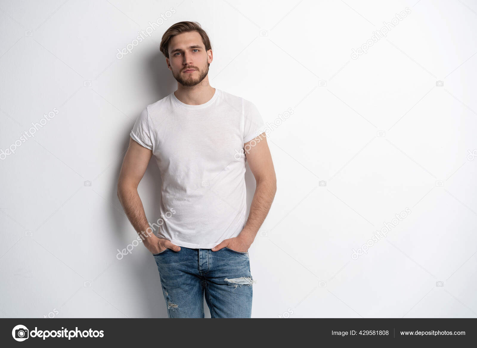 Portrait of a smart young man standing against white background. Stock ...