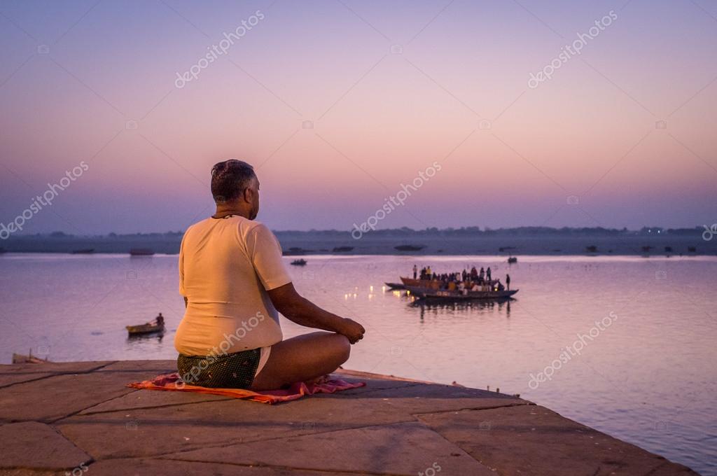 Indian man meditates next to Ganges river — Stock Editorial Photo ...