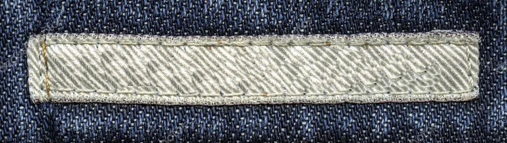 Gray textile tag on blue jeans background — Stock Photo © natalt #82256226