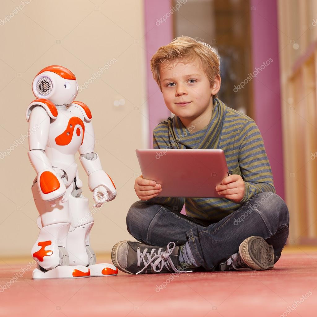 Child playing and learning with robot Stock Photo by ©coendef 65243655
