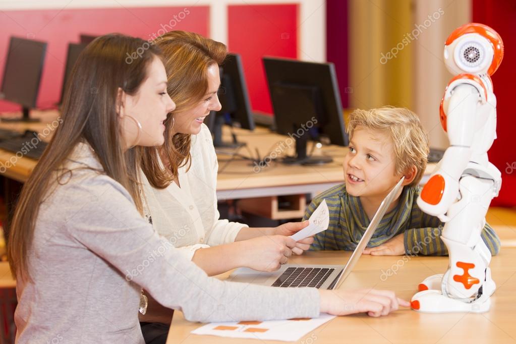 Female teacher programming robot with children Stock Photo by ©coendef ...