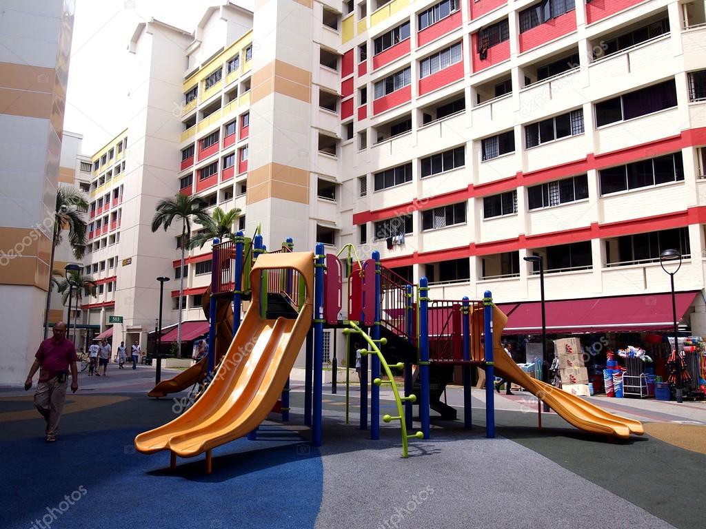 A playground in the middle of two HDB buildings in the town of Tampines ...