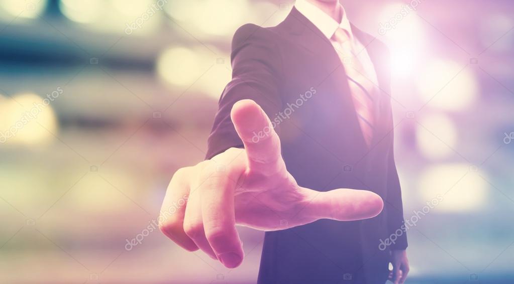 Businessman touching a touch screen Stock Photo by ©Melpomene 65311181