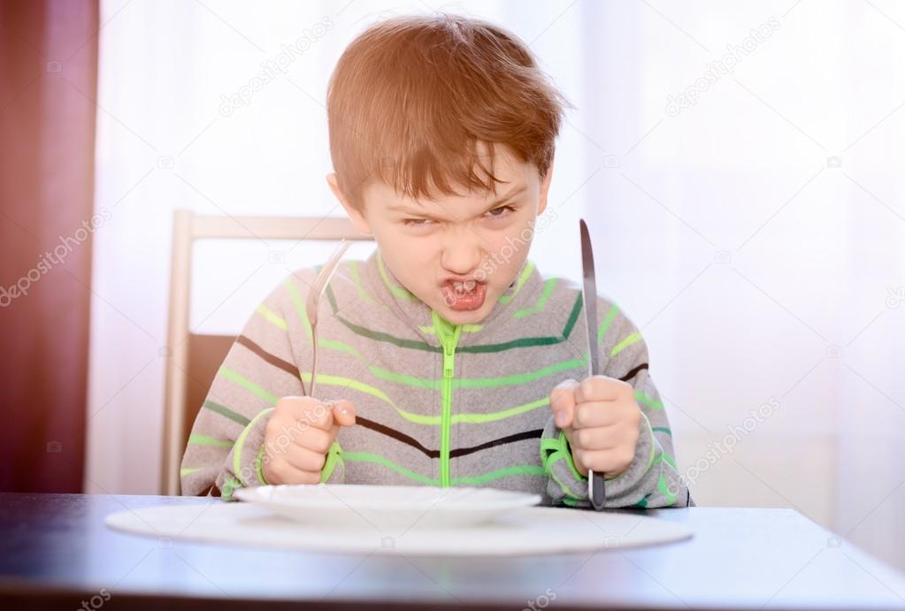 Angry hungry boy child waiting for dinner Stock Photo by ©djedzura ...