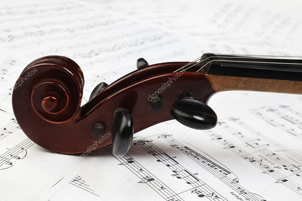 Violin scroll and music sheet Stock Photo by ©alenavlad 59708353