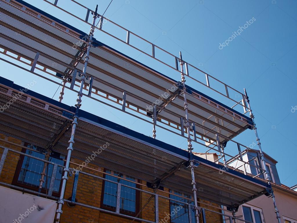 Scaffolds on a house building under renovations — Stock Photo ...