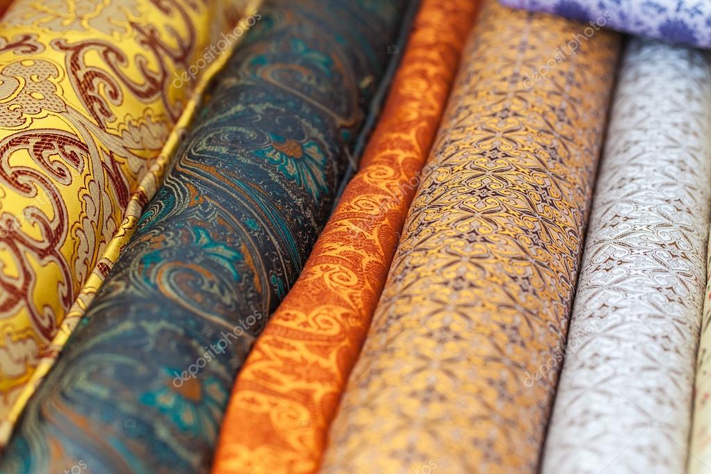 Rolls of fabric and textiles in a factory shop — Stock Photo ...