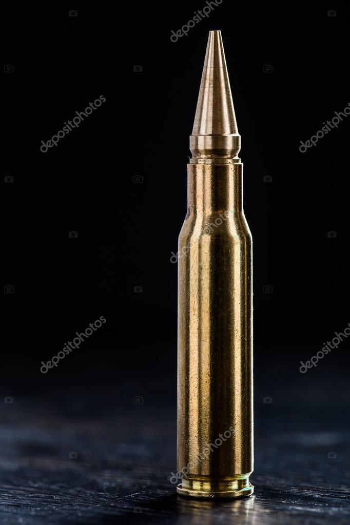 Large-caliber cartridge on a dark background Stock Photo by ©bezikus ...