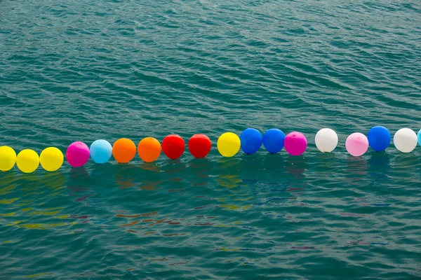 Balloons floating in swimming pool. — Stock Photo © poznyakov #6724124