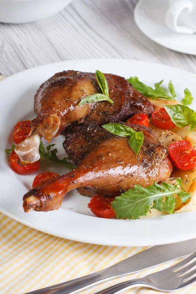 Duck legs baked with apples and tomatoes close-up top view Stock Photo ...