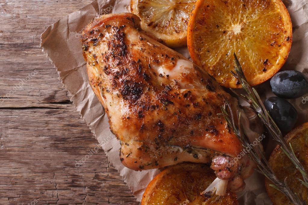 Roasted rabbit leg with oranges, olives and rosemary top view — Stock ...