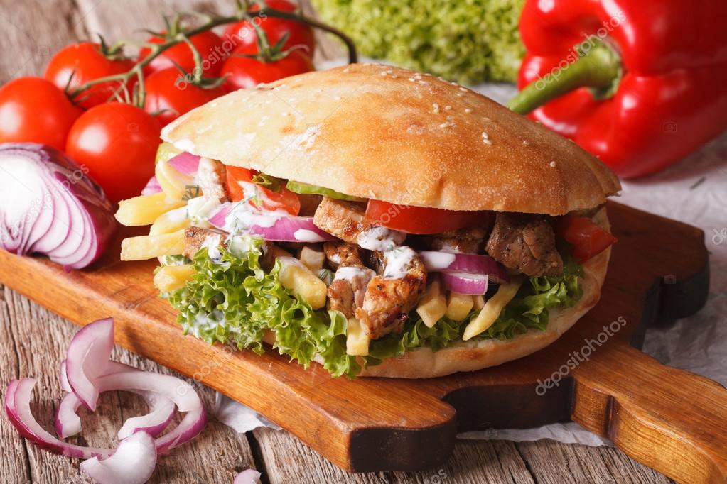 Doner kebab with meat, vegetables and french fries closeup. hori ...