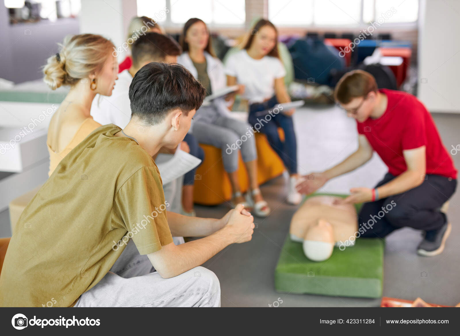 Young people learning how to safe a life sitting together on lesson ...